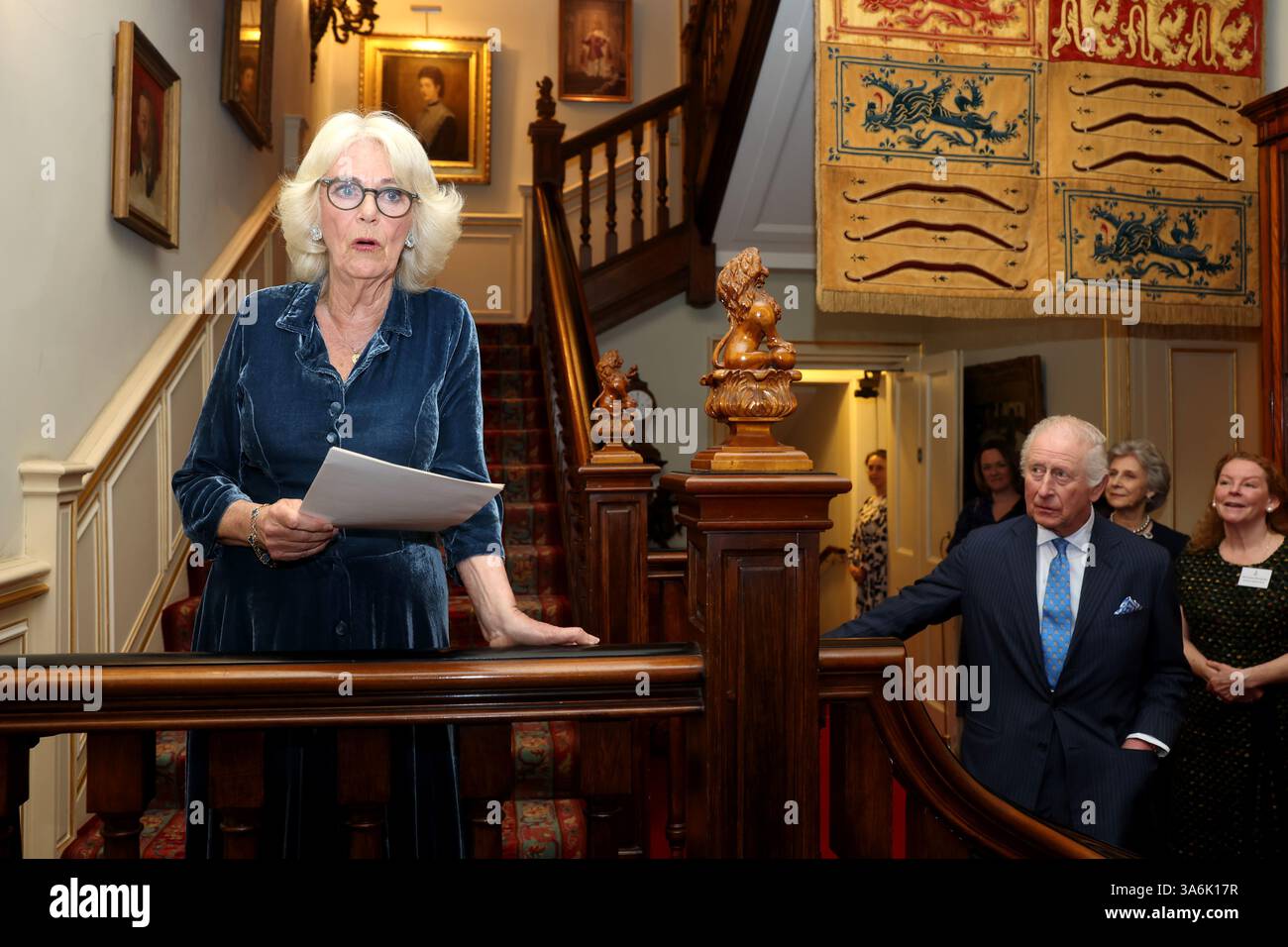 Queen Camilla, watched by King Charles III, speaking during a reception at Clarence House ...