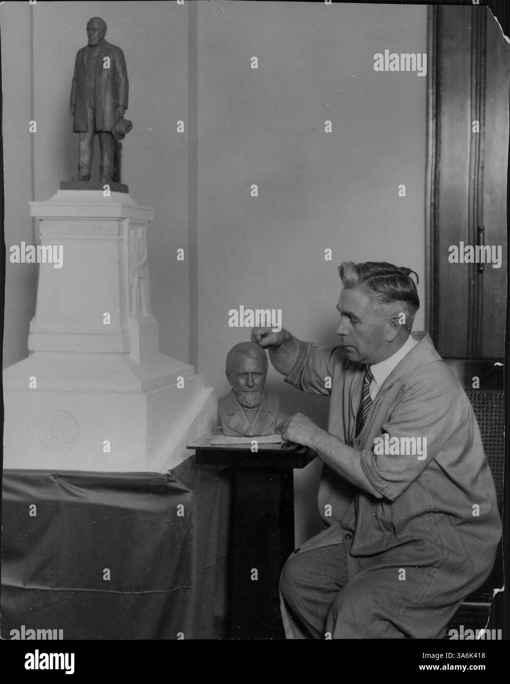 Sculptor John K. Daniels is working on a clay model of a statue ...