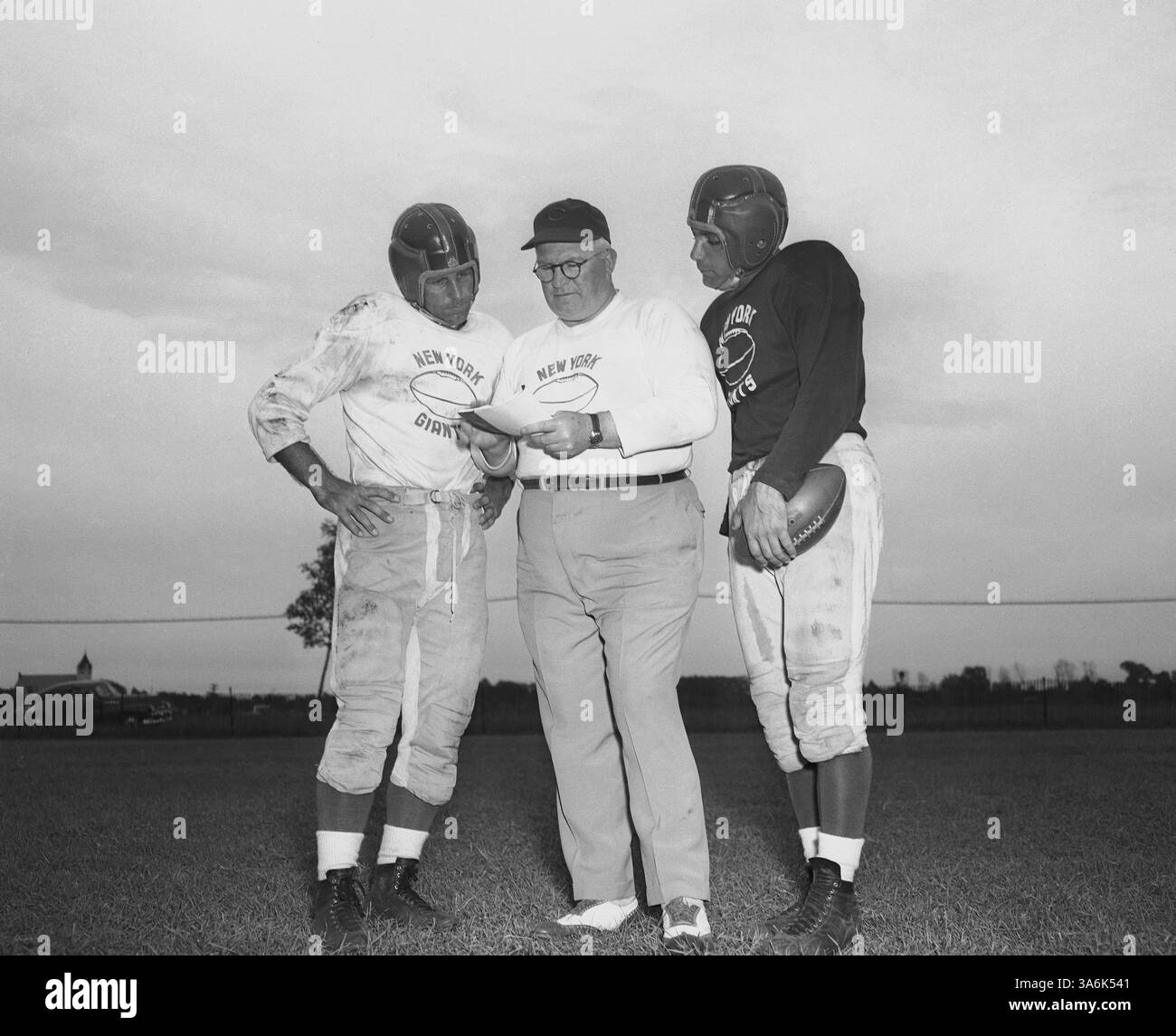 New York Giants head coach Steve Owen, center, talks with quarterbacks ...