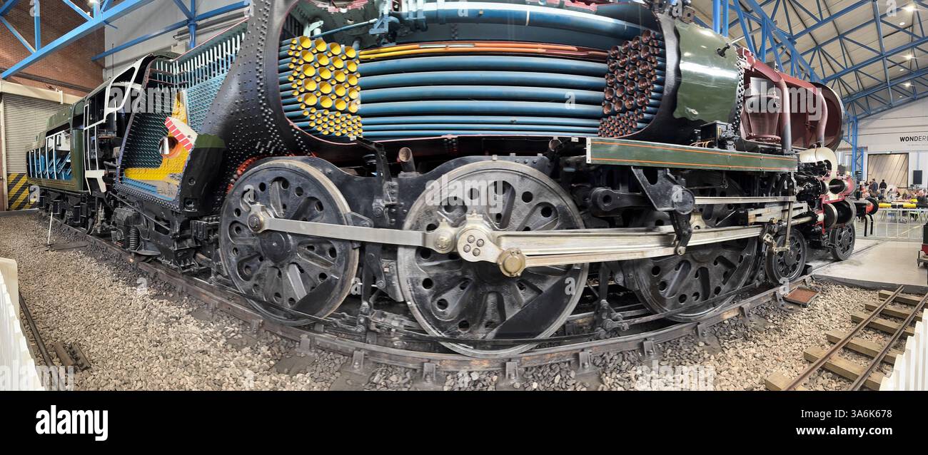 Cutaway view of a steam engine locomotive on tracks, revealing internal ...