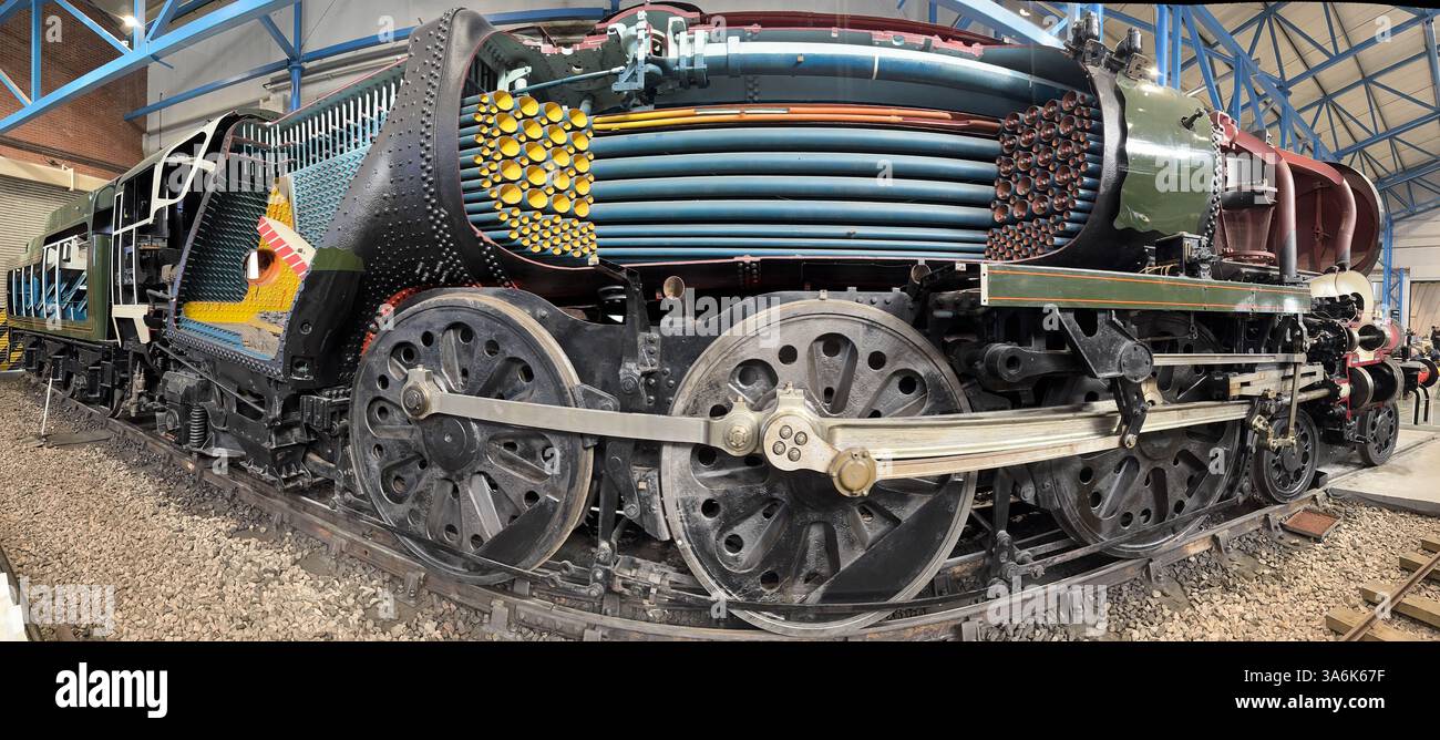 A sectioned steam locomotive is on display, revealing interior ...