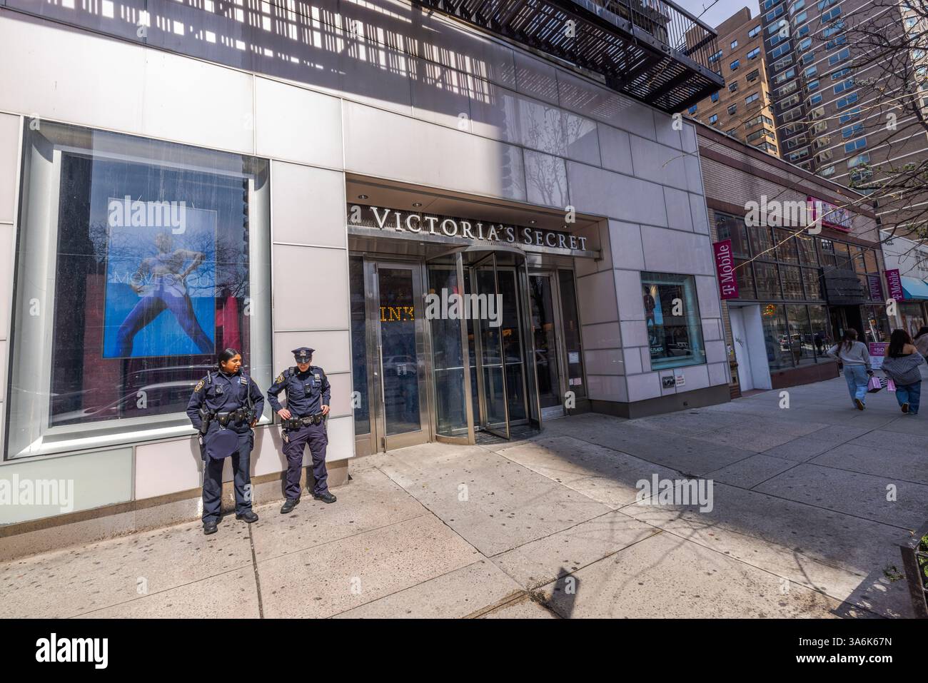 Police officers standing outside Victoria's Secret entrance on sunny ...