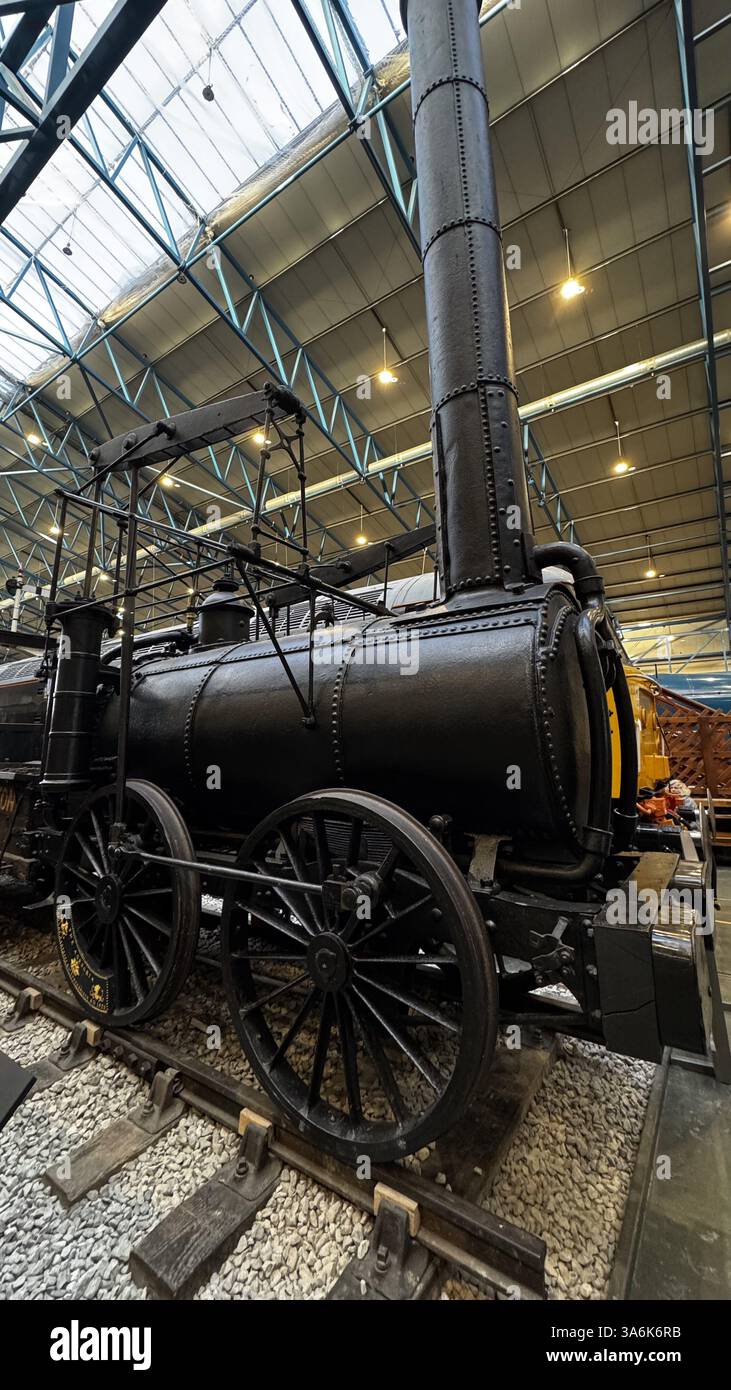 A black steam locomotive is centered, dominating the view inside a ...