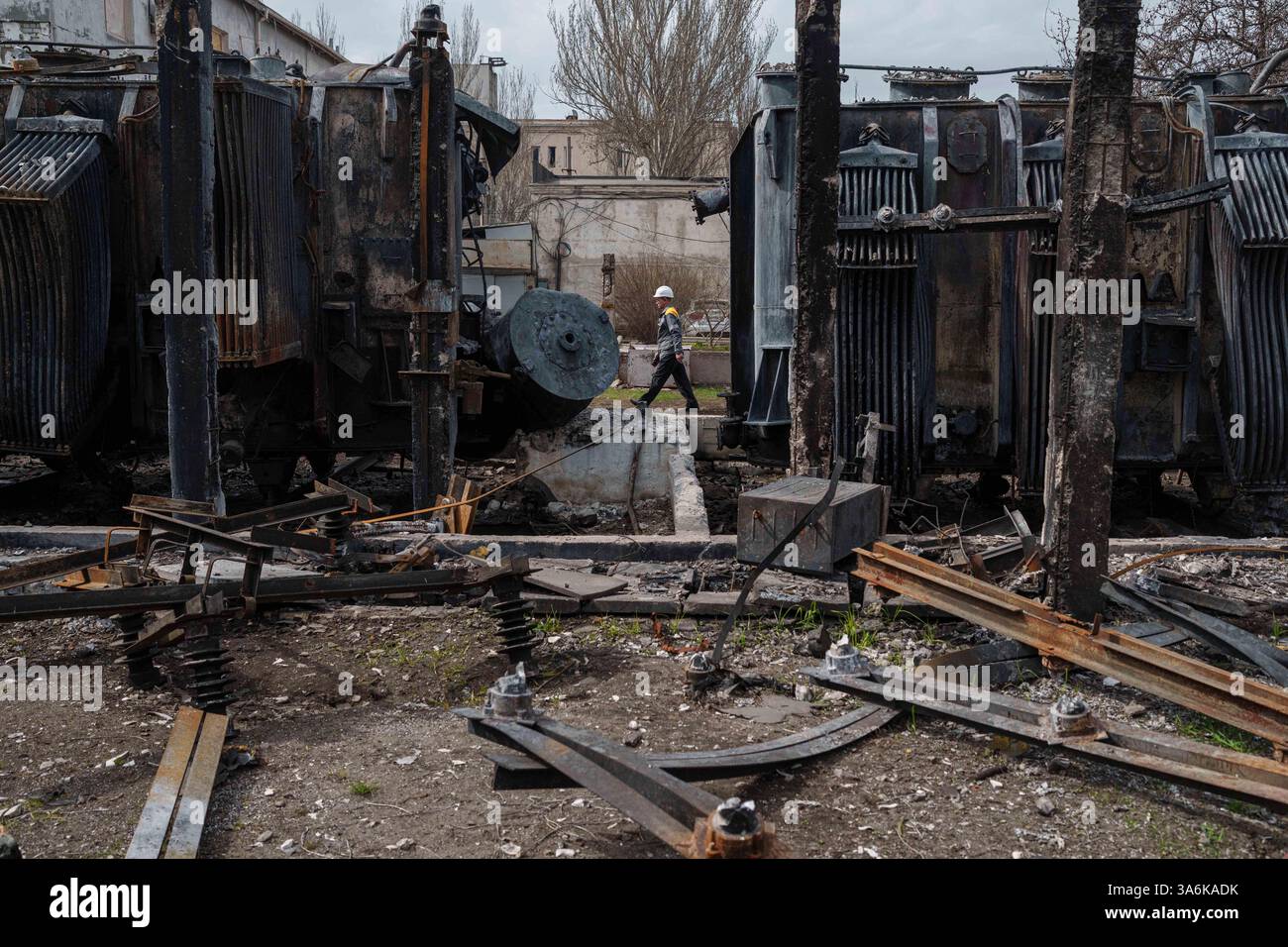 A worker of DTEK company walks in front of transformers of a substation ...
