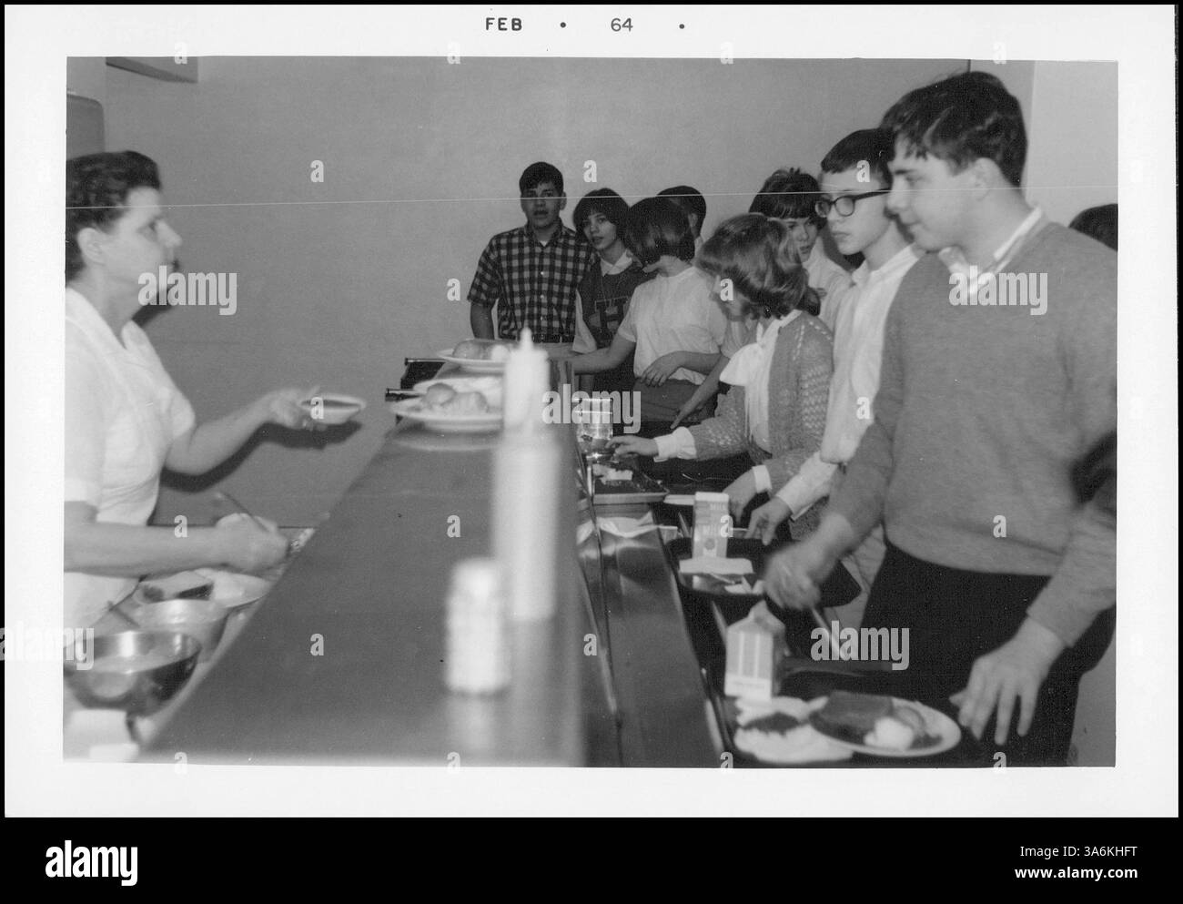 Cafeteria workers serve nutritious school lunches, providing balanced ...