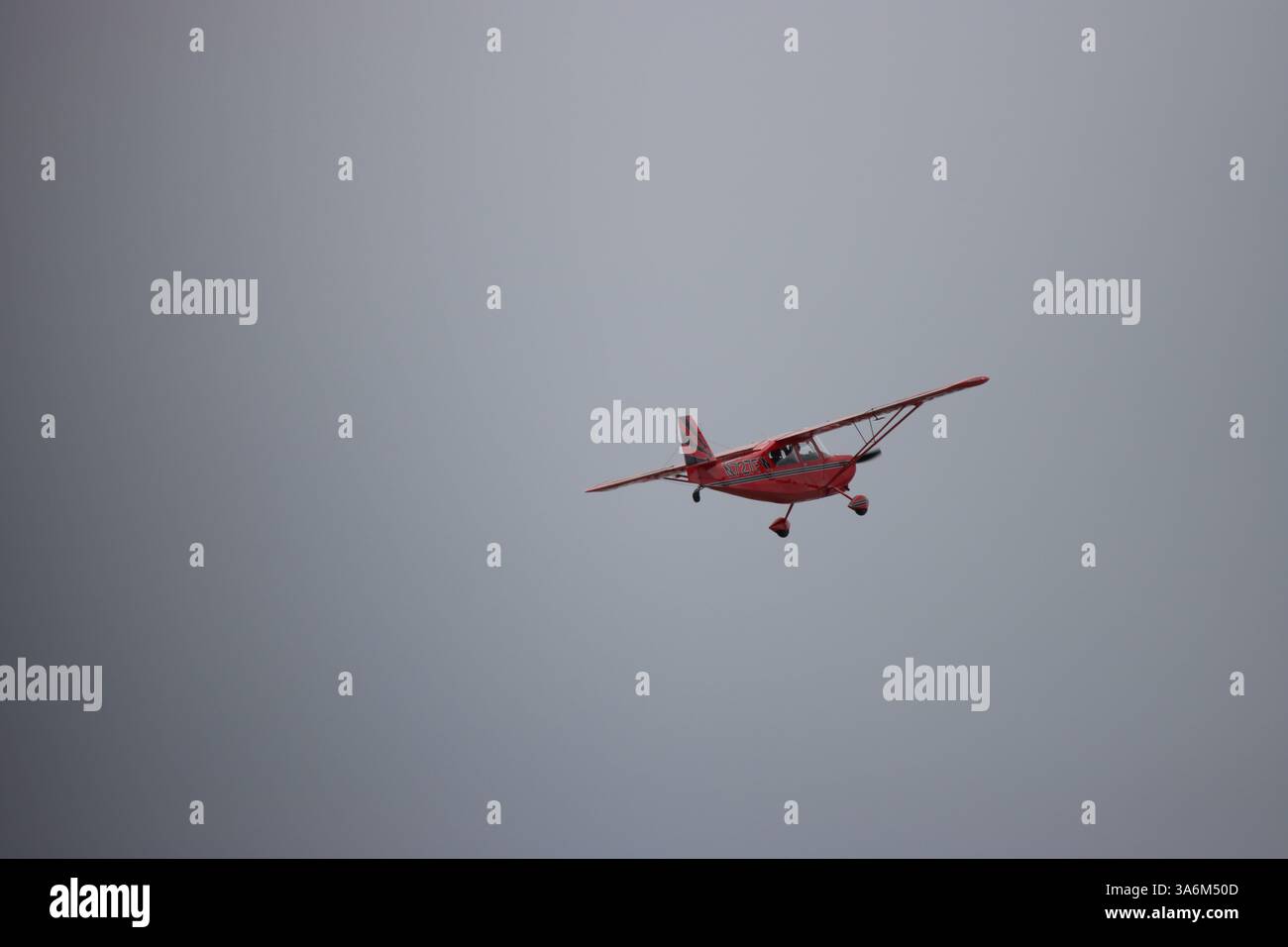 Red American Champion Super Decathlon 8KCAB climbing away after takeoff ...