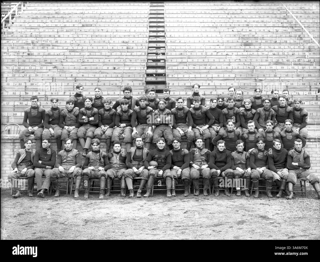The University of Minnesota football team, posed on the bleachers in a ...