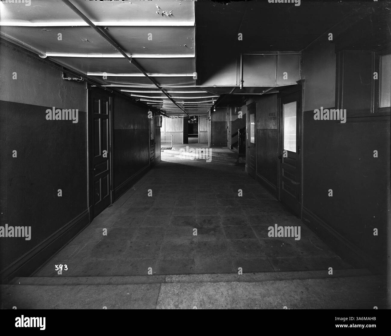 The basement corridor of Adams School is depicted in a historical ...