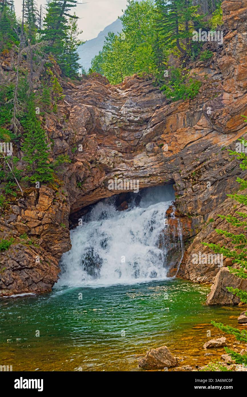 Waterfall Coming Through a Tunnel at Running Eagle Falls in Glacier ...