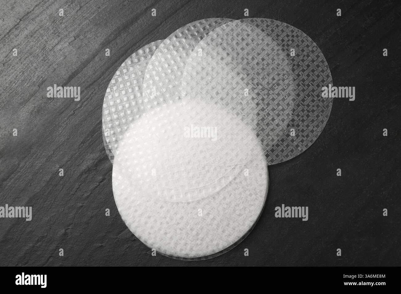 Edible rice paper sheets on dark textured table, flat lay Stock Photo ...