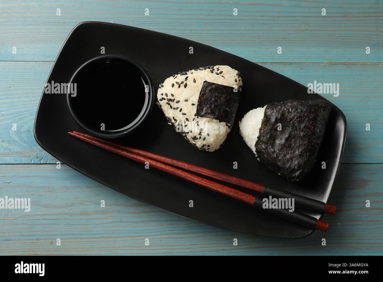 Rice balls (onigiri) served on light blue wooden table, top view ...