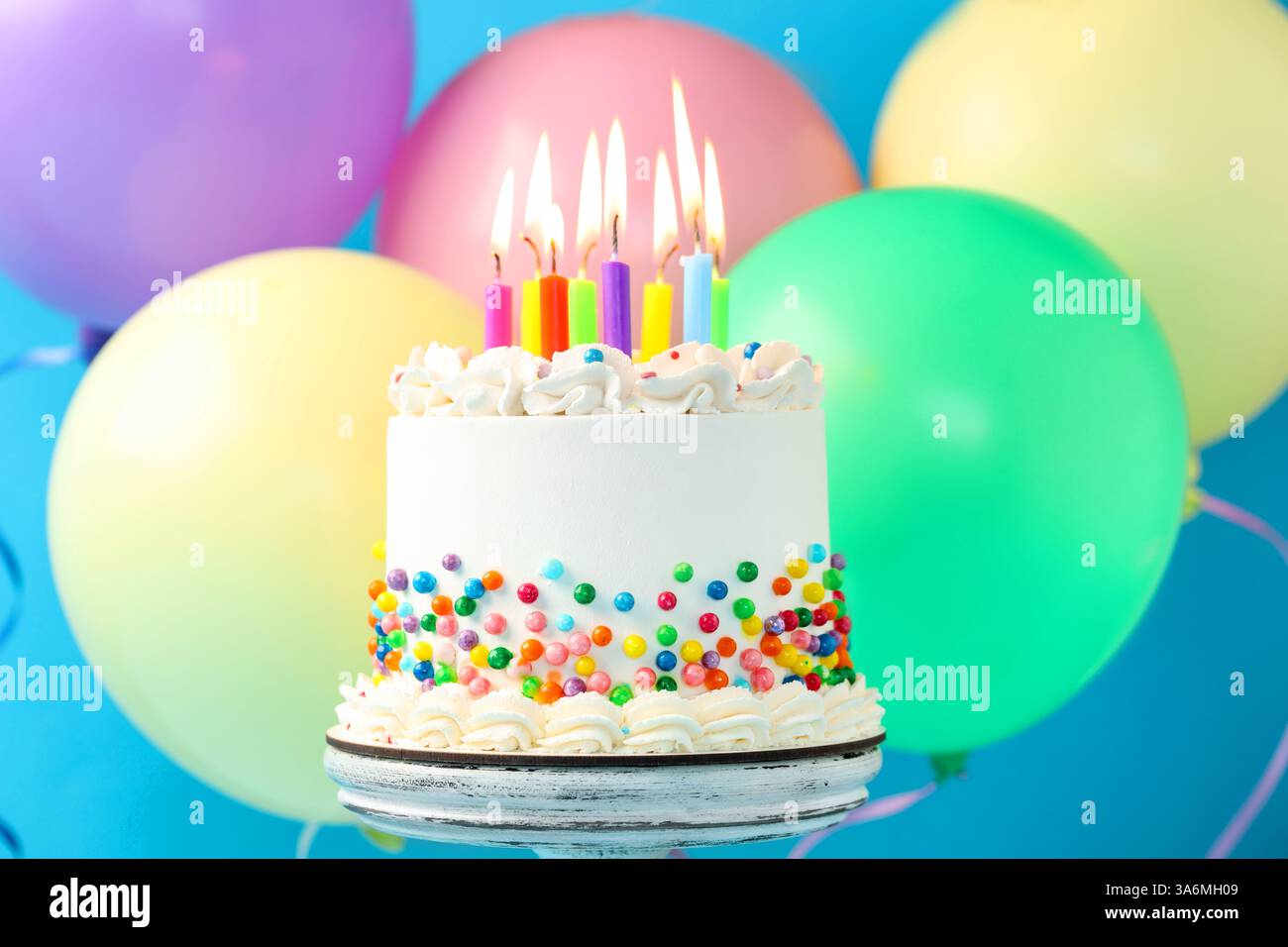 Delicious bento cake with sprinkles, burning candles and colorful ...