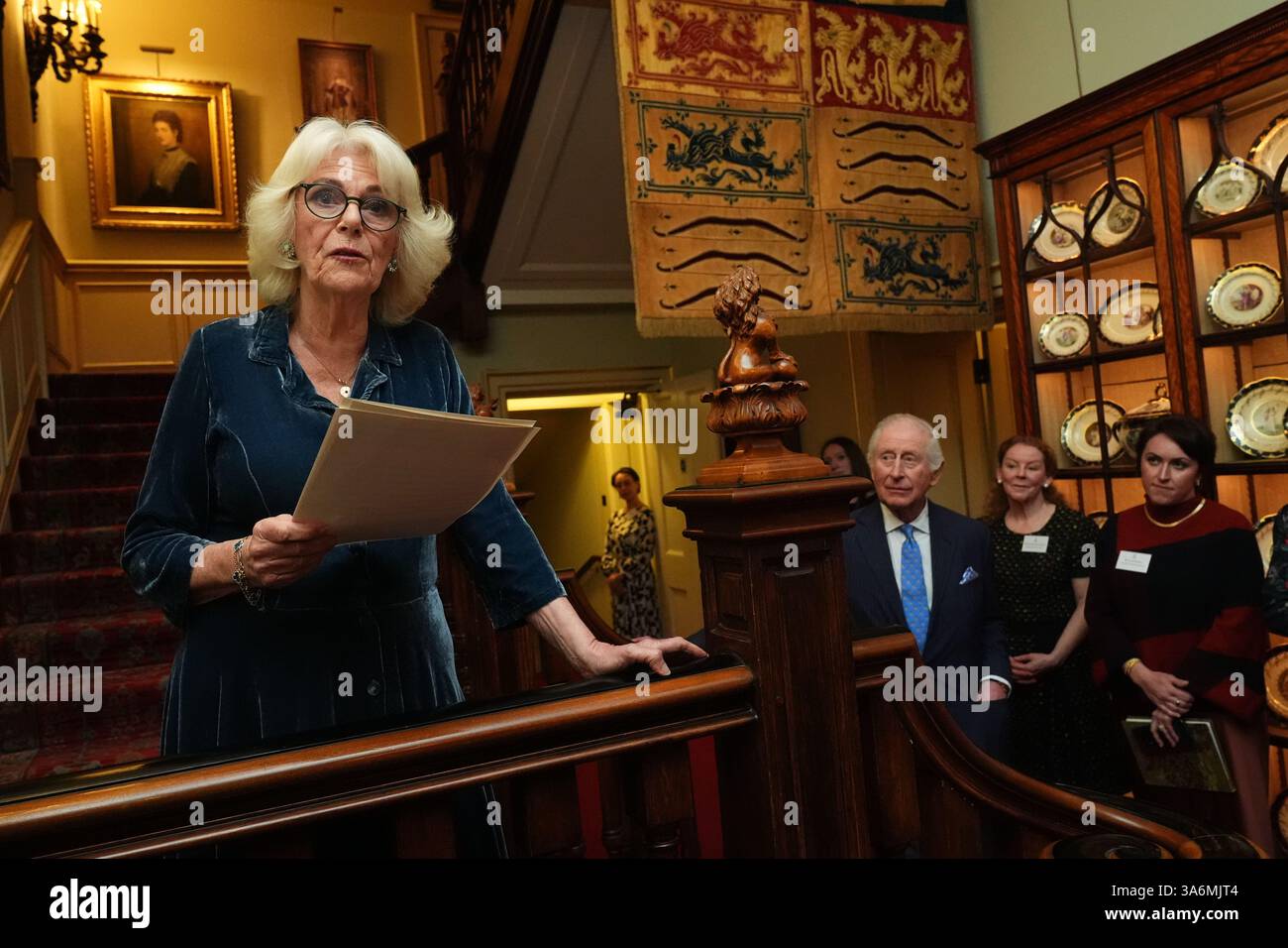 Queen Camilla, joined by King Charles III, speaks during a reception at Clarence House, London ...