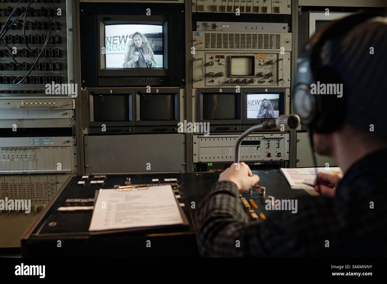 Focus on TV set with young female journalist speaking in microphone on ...