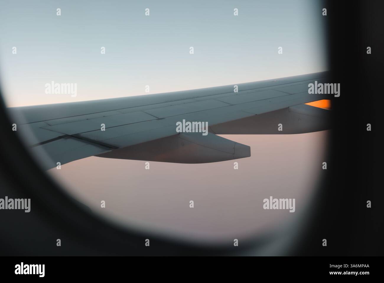 A Stunning Airplane Wing View Captured During a Beautiful Sunset Flight ...