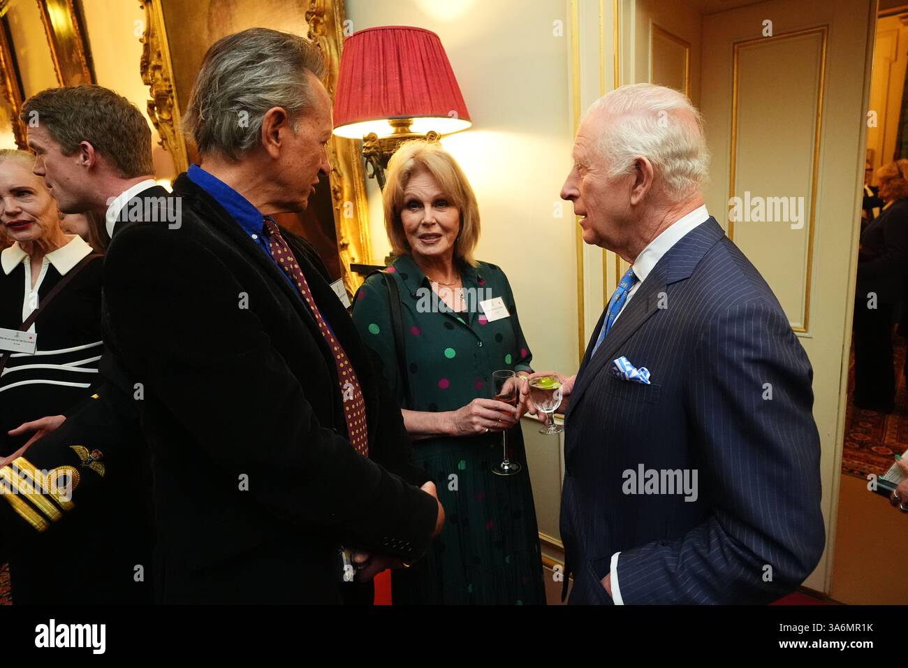 King Charles III with Dame Joanna Lumley during a reception at Clarence House, London, for ...