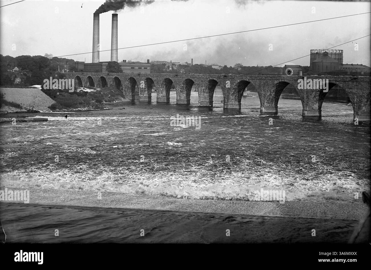 This image shows St. Anthony Falls with the Stone Arch Bridge in the ...