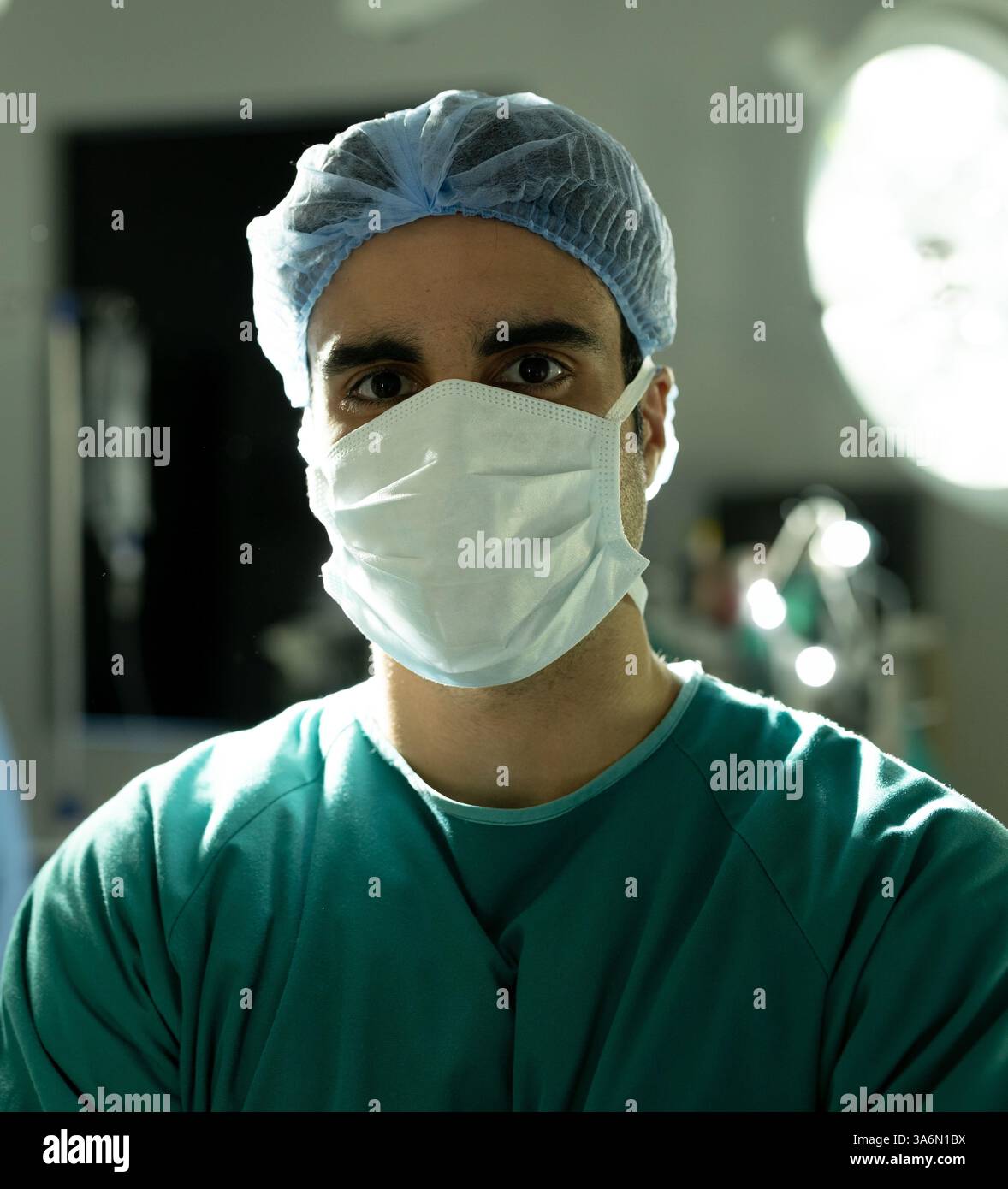 Medical professional wearing surgical mask and cap in hospital ...