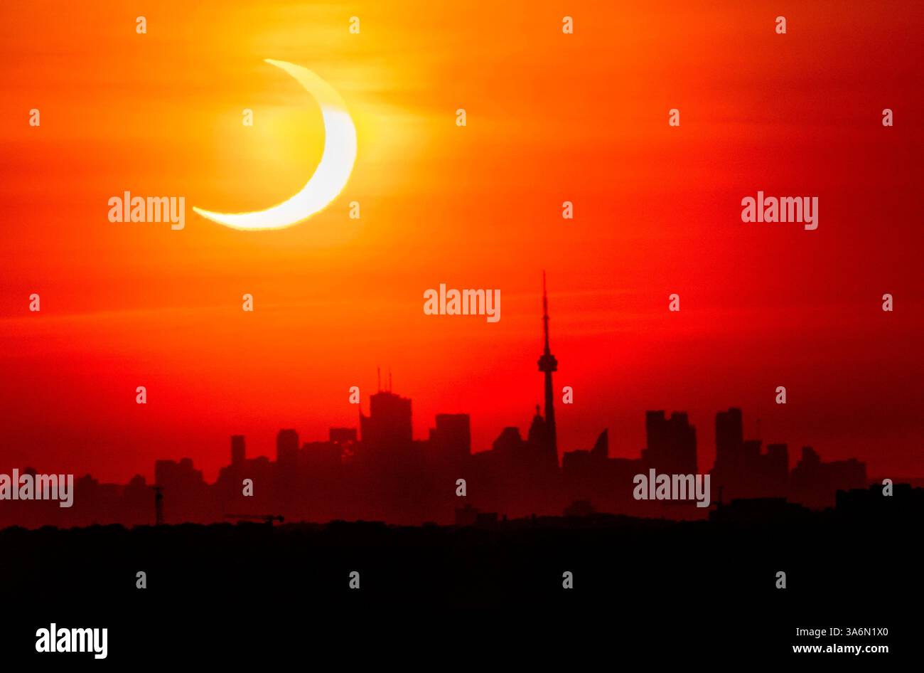 FILE - An annular solar eclipse rises over the skyline of Toronto, June ...