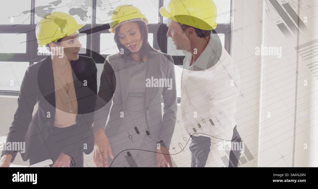 Business professionals wearing hard hats discussing project plans in ...