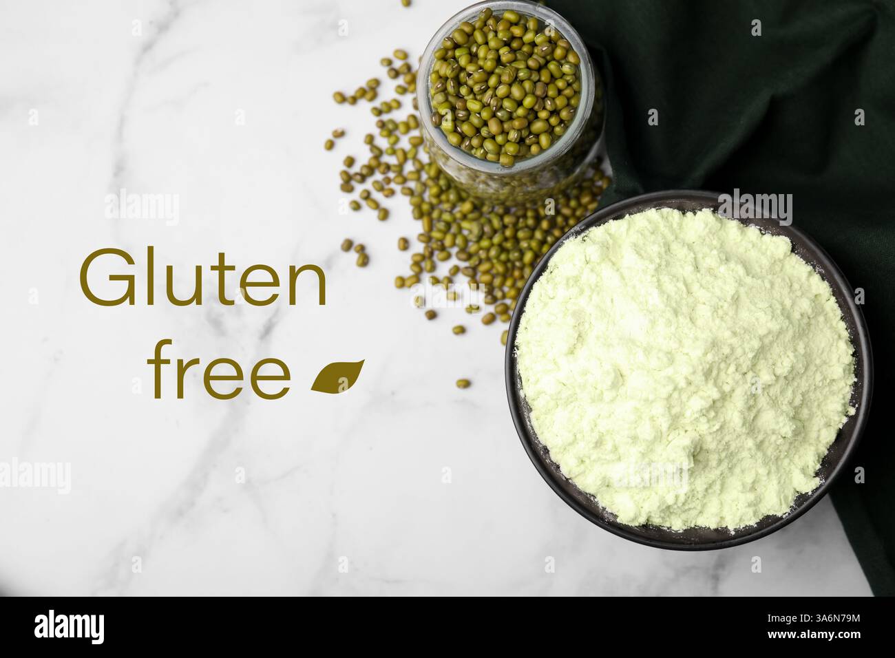 Gluten-free mung bean flour in bowl on white marble table, top view ...