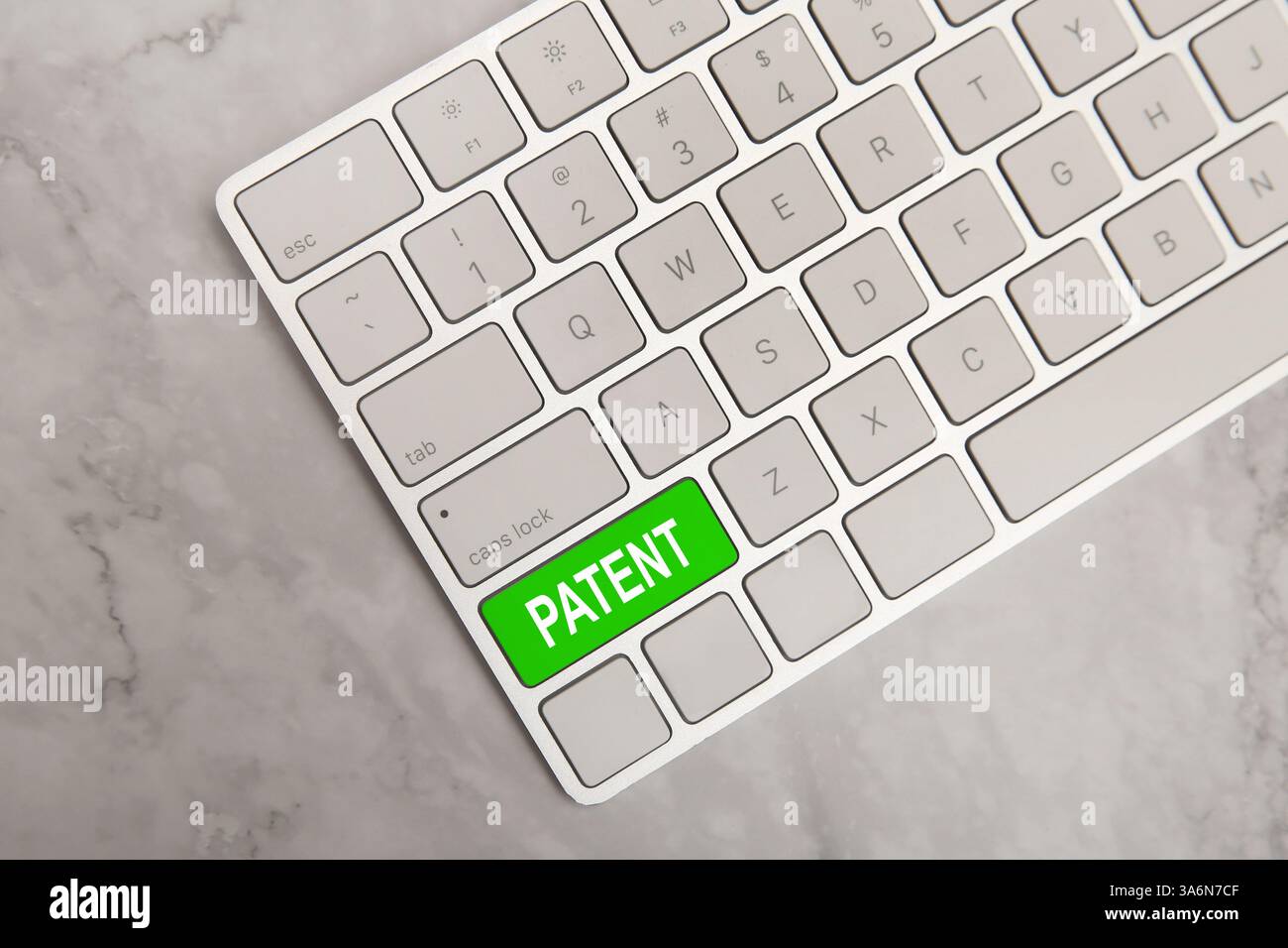 License. Computer keyboard with word Patent on green button, top view ...