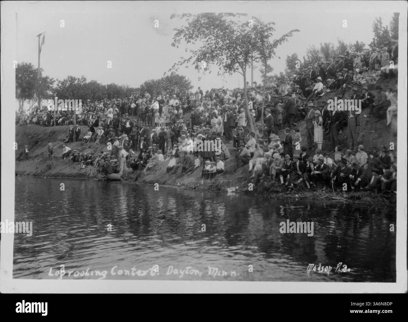 Spectators watch a log rolling contest along the Mississippi River ...