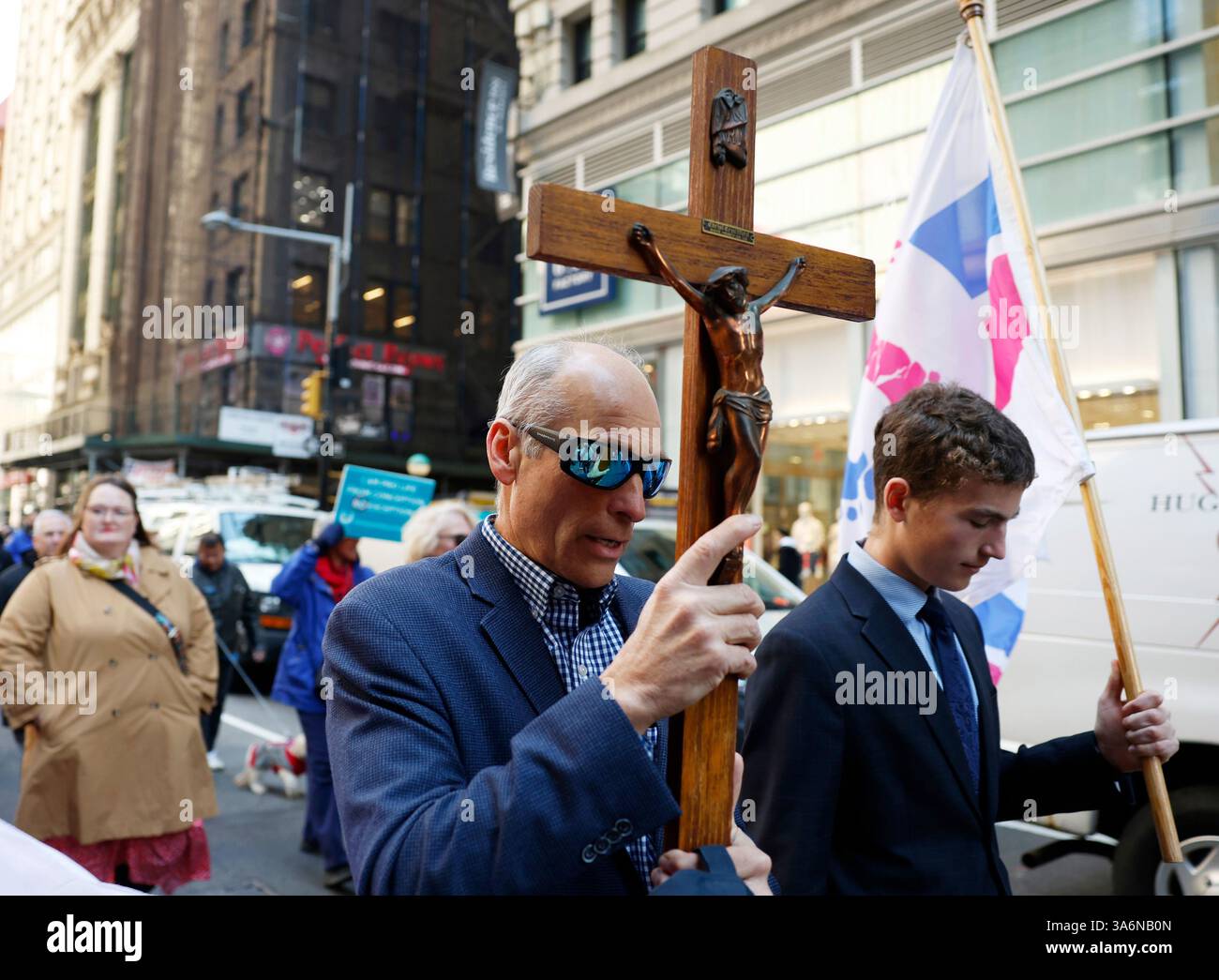 Anti-Abortion activists hold crucifixes and signs when they march at ...