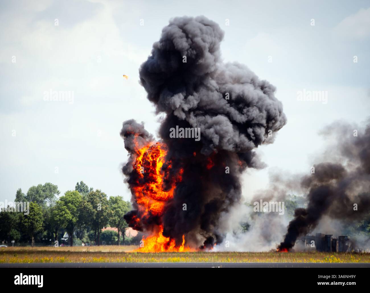Large explosion with black smoke Stock Photo - Alamy