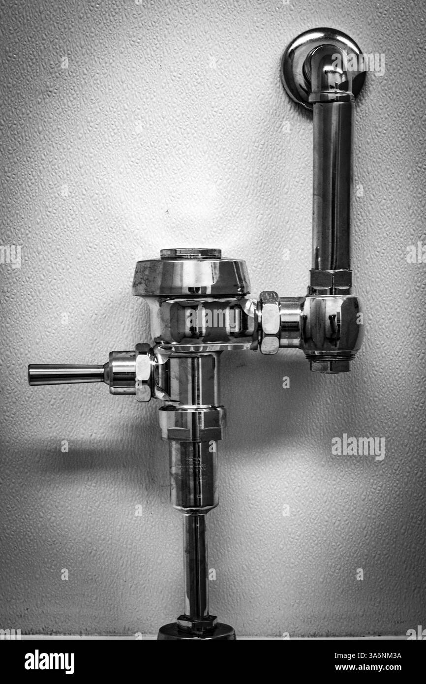 Plumbing, handle and valve to flush a urinal in the men's restroom ...