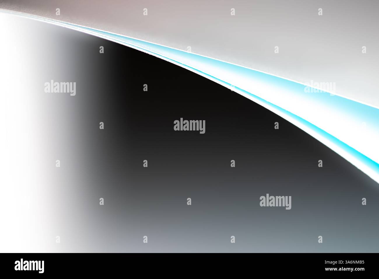 Curved edges of textured paper are showcased, revealing a soft blue ...