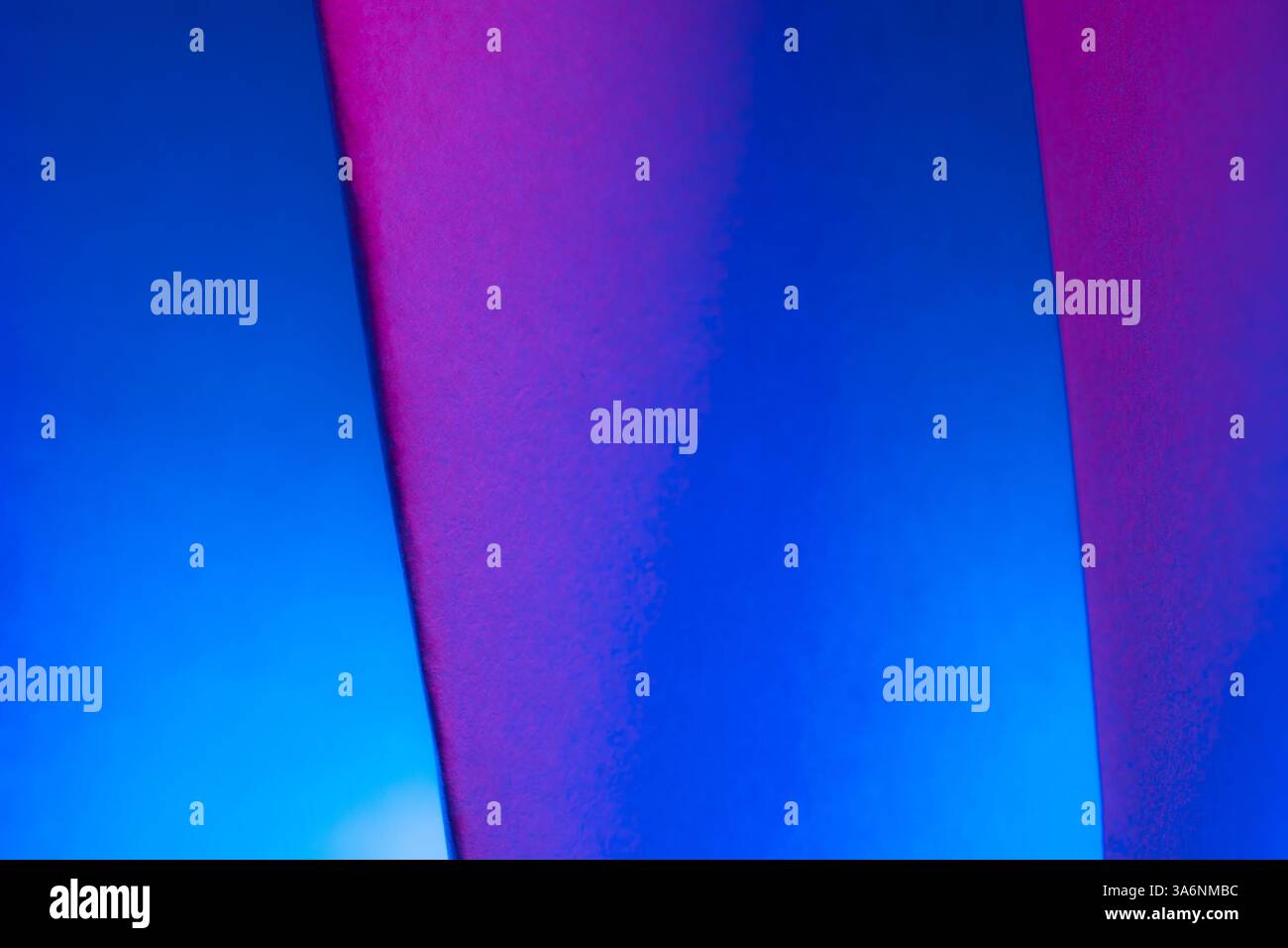 A striking arrangement of pink and blue paper forms two overlapping ...