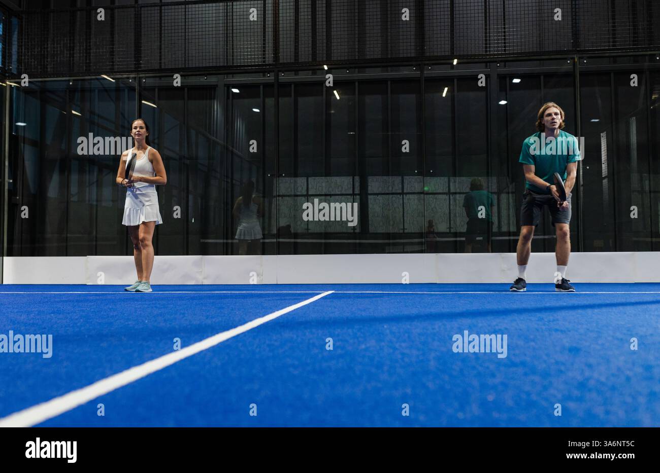 Playing padel tennis focused players hi-res stock photography and ...