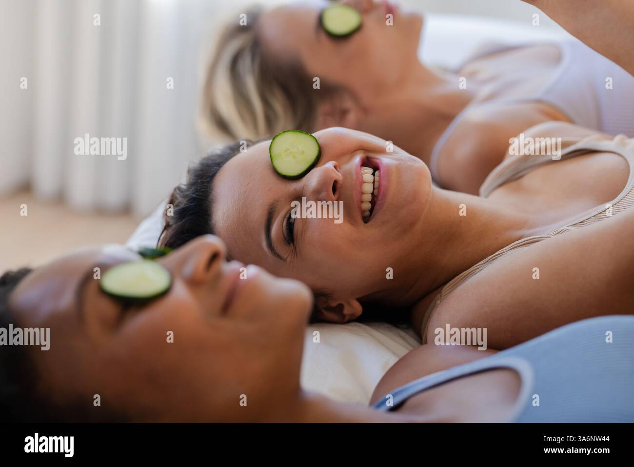 Relaxing together, diverse female friends enjoying spa day with ...