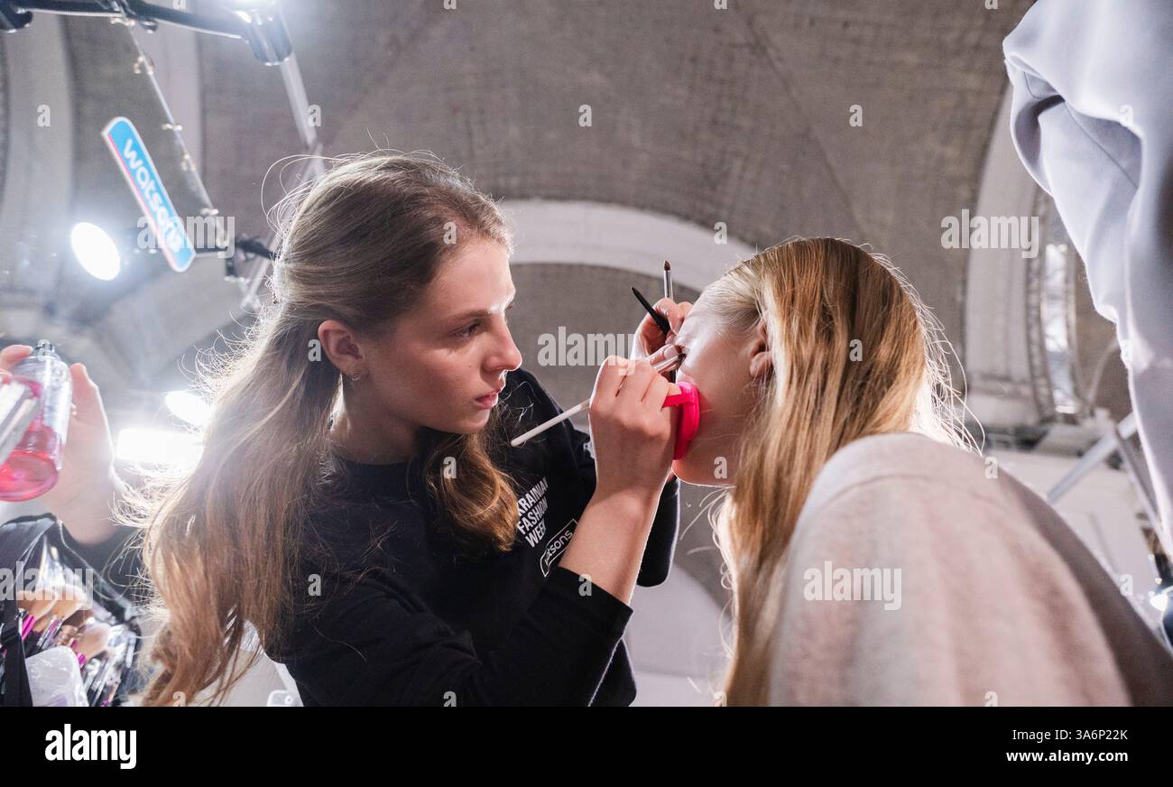 Kyiv, Ukraine - 14th February, 2025: Creative artists apply makeup and finalize looks for models ...