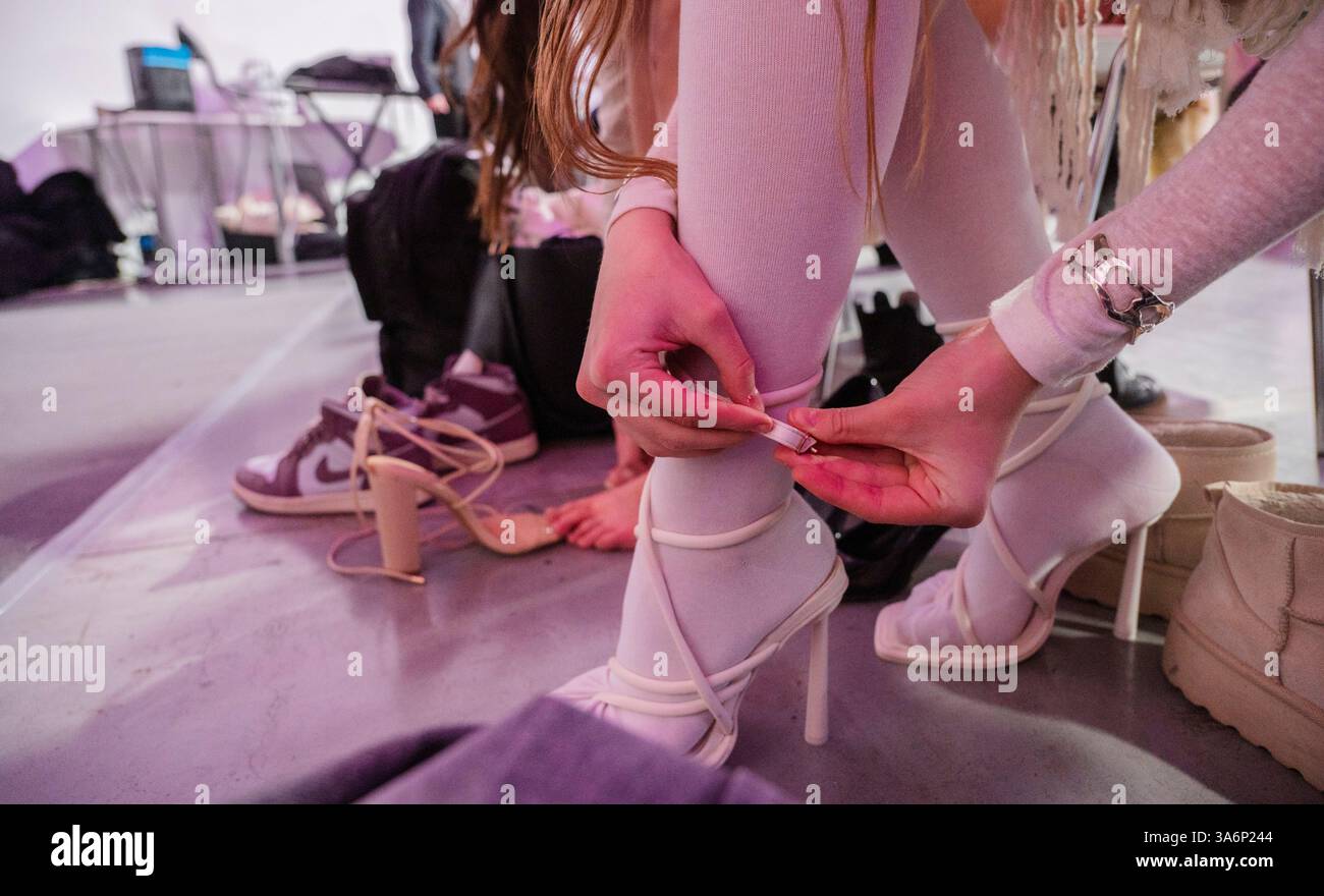 Kyiv, Ukraine - 14th February, 2025: Models adjust outfits and stylists ...