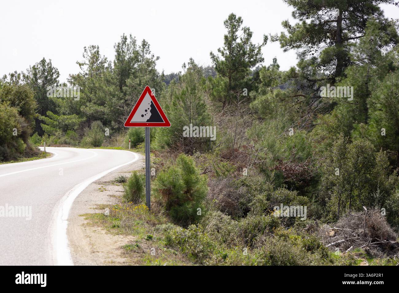 Winding Road with Landslide Warning Sign in Forested Area Stock Photo ...