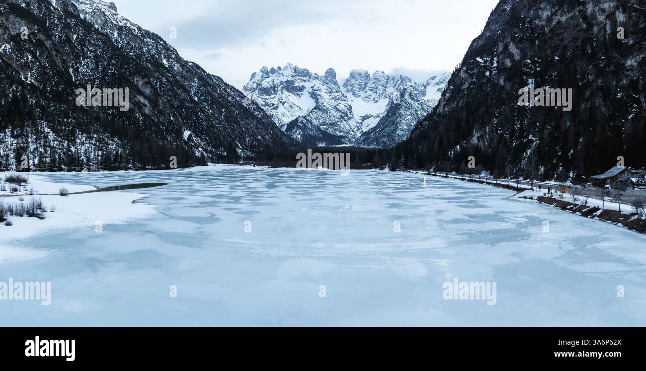 Frozen Lake with Snow Covered Peaks and Forests in the Alps Stock Photo ...