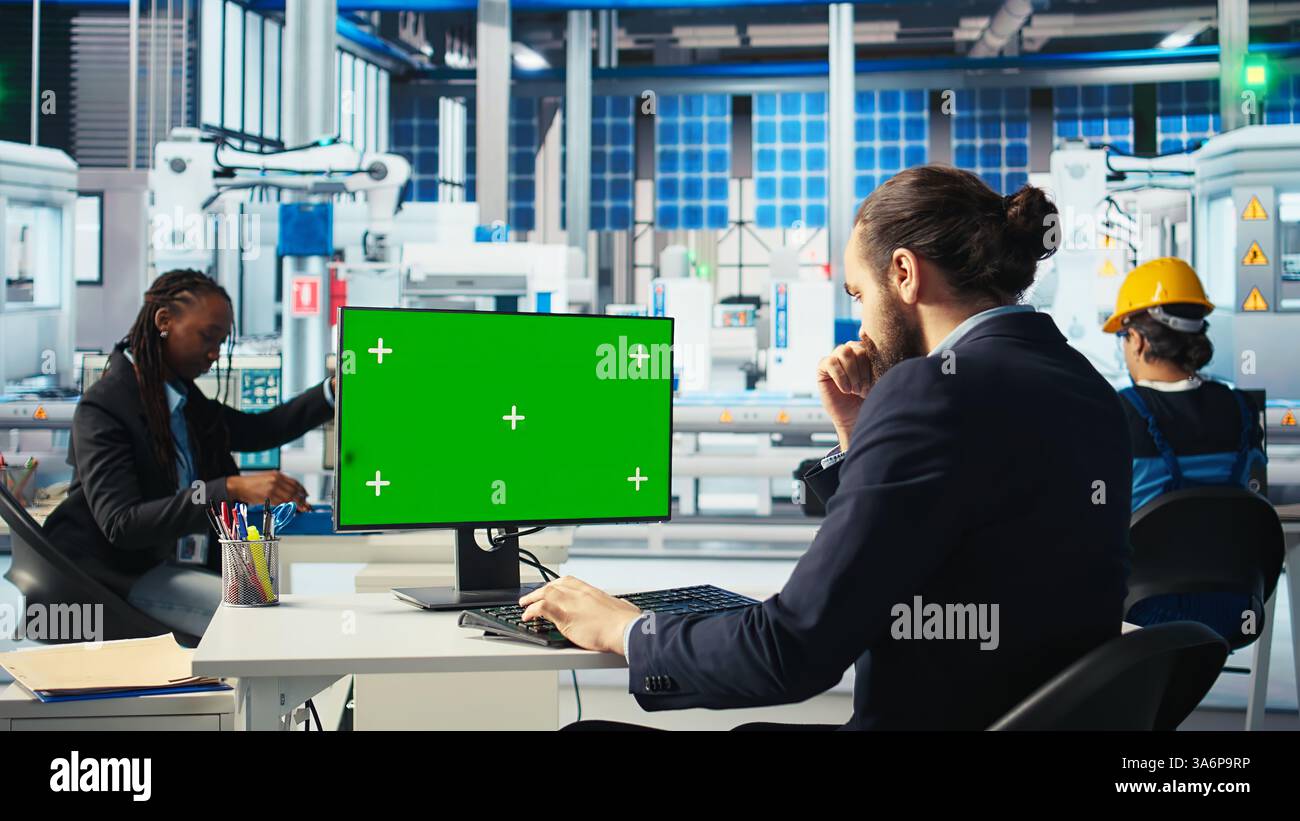 Photovoltaics factory worker analyzing data on green screen PC, reviewing system metrics. Solar ...