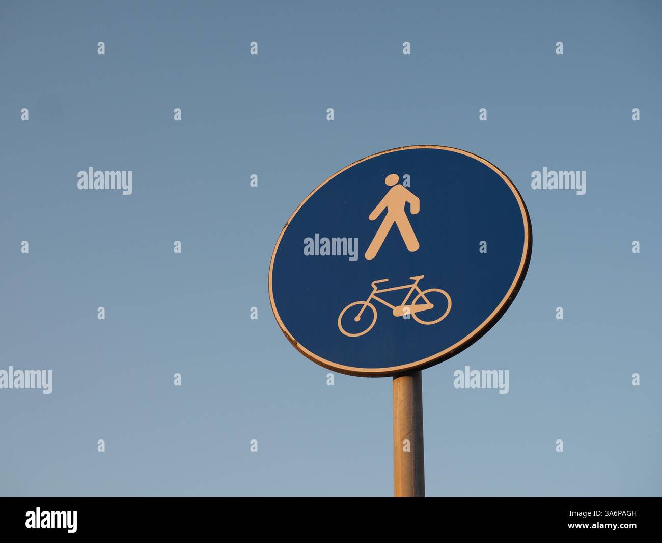 pedestrian zone and bike lane sign over blue sky Stock Photo - Alamy