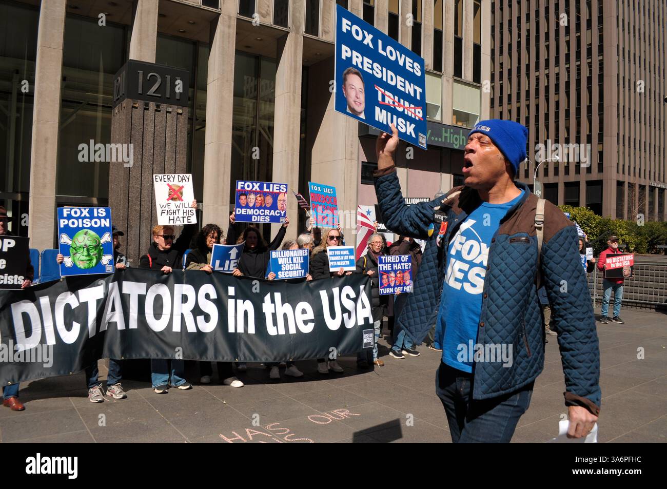 New York, United States. 25th Mar, 2025. Demonstrators hold a banner ...
