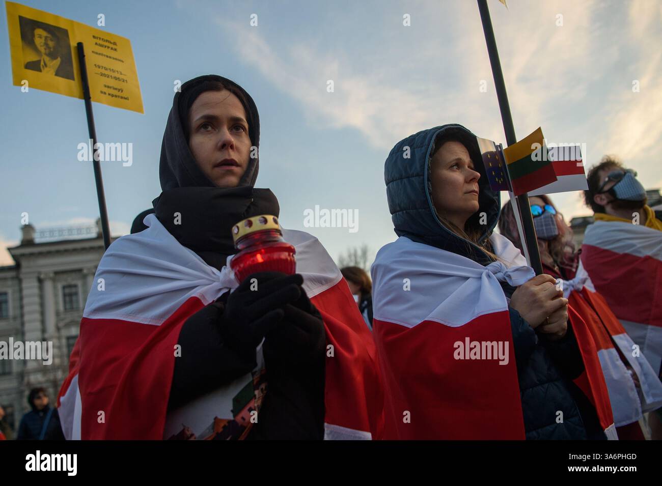 People draped with Belarusian national flags attend a rally in honor of ...