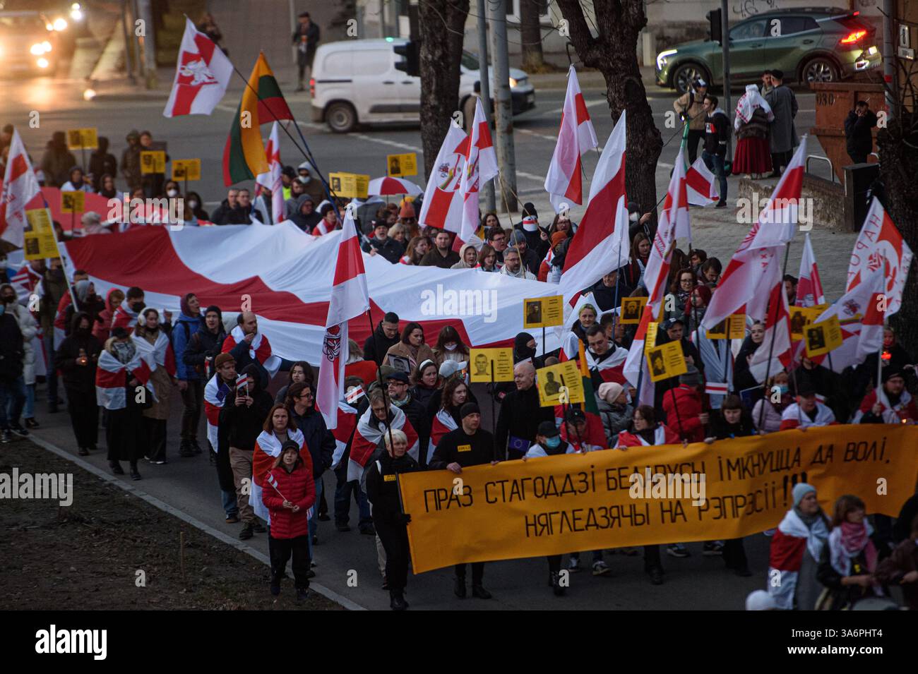 Vilnius, Lithuania. 25th Mar, 2025. People carry a huge Belarusian ...