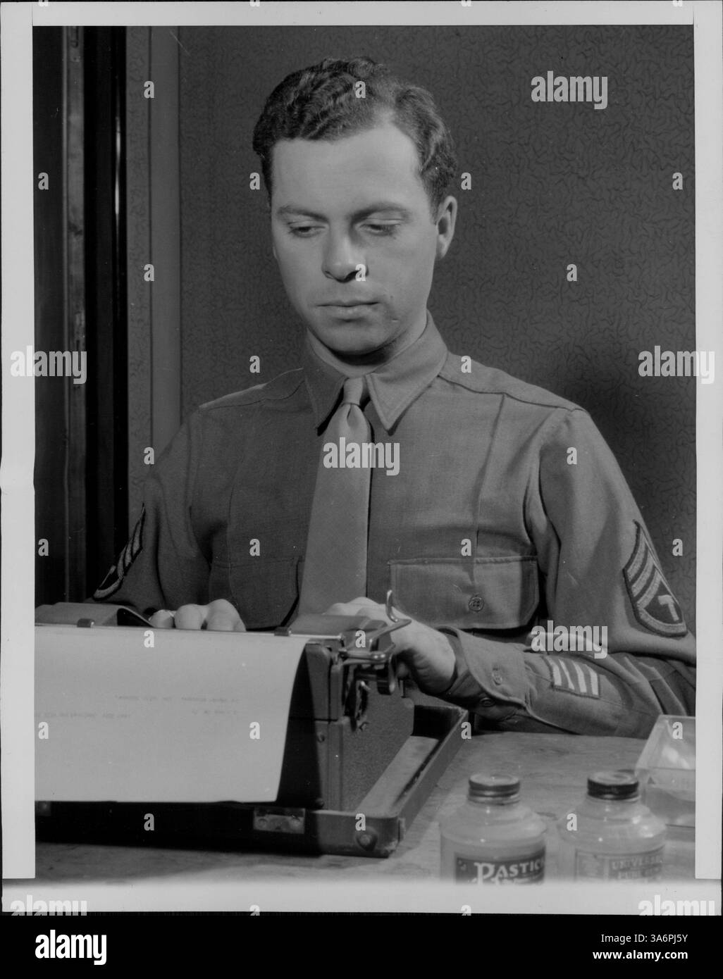 Roy M. Owen is captured preparing a typewritten report at an American ...