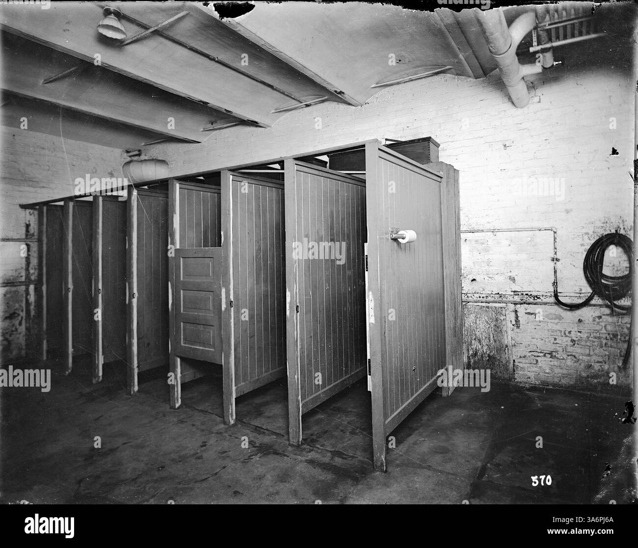 A historical photograph showing the boys' restroom in the basement of ...