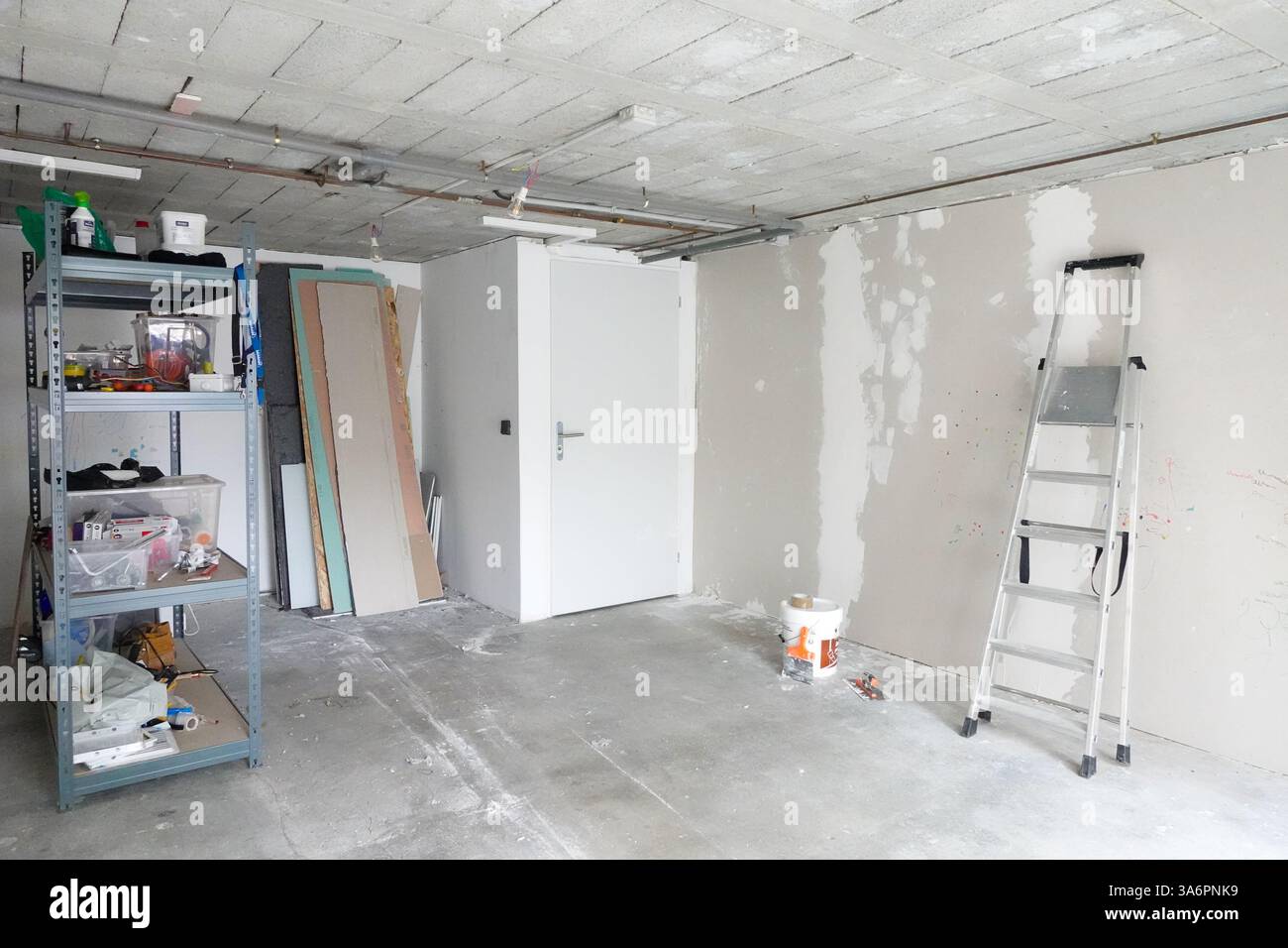 Unfinished Garage Interior with Storage Shelves Stock Photo - Alamy