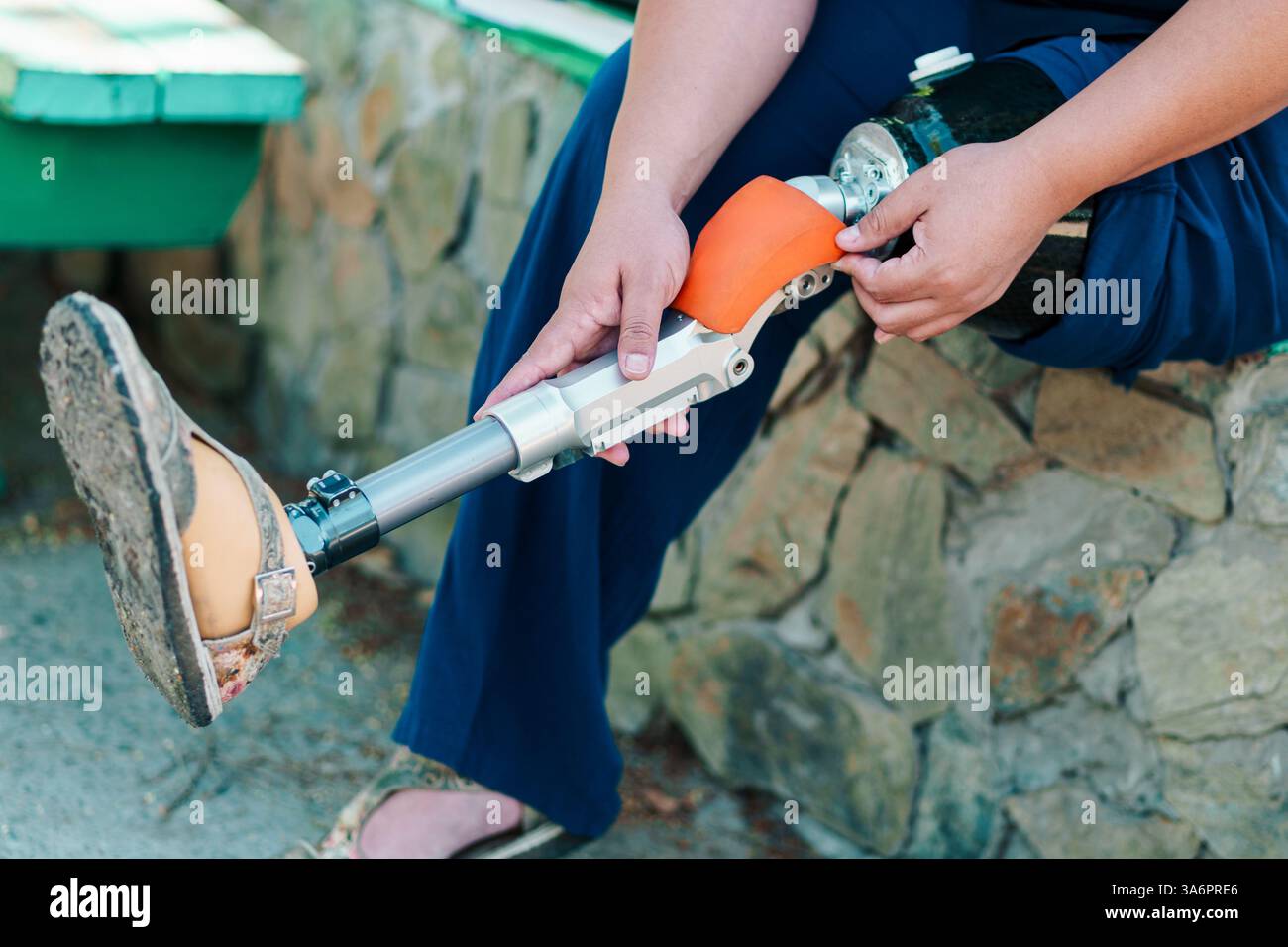 View of a Latina woman's prosthetic leg working on her computer in a ...