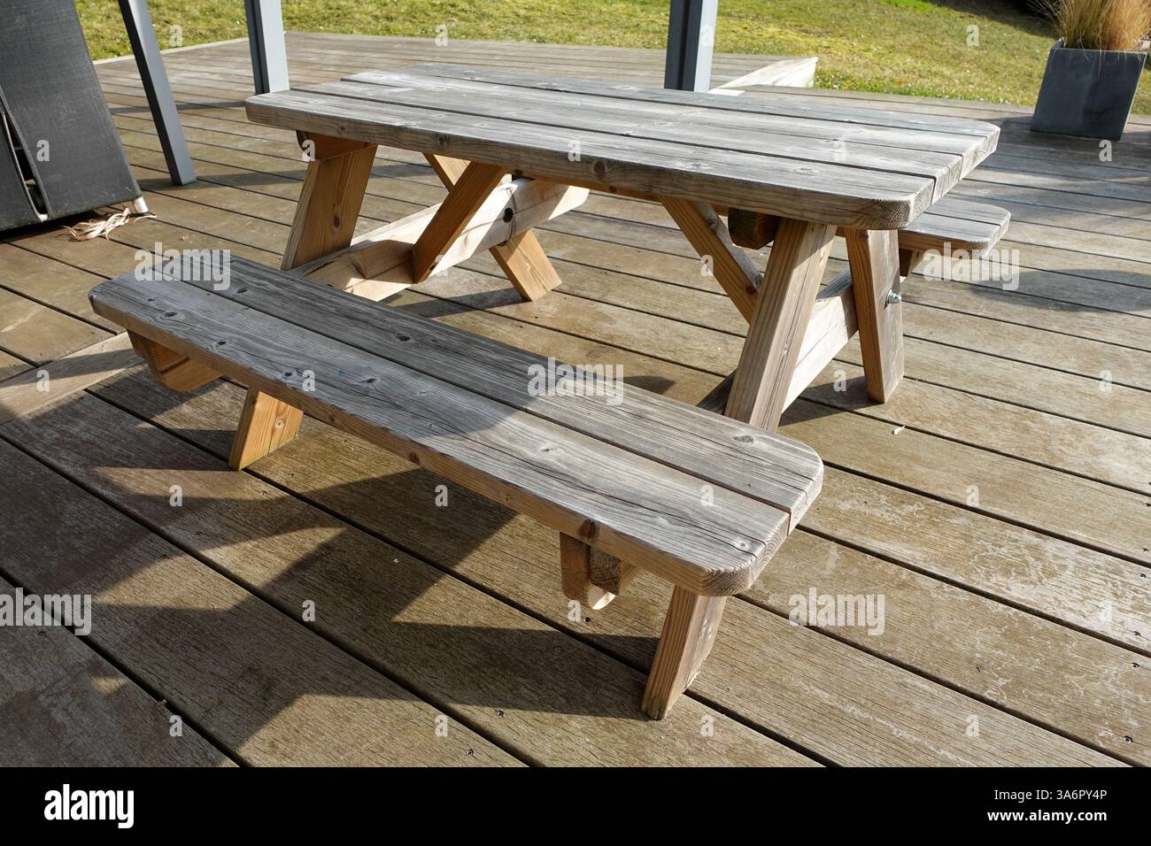 Rustic Wooden Picnic Table on Sunlit Deck Stock Photo - Alamy