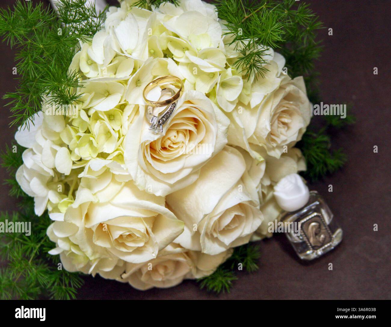 Wedding Rings on Roses and Holy water Stock Photo - Alamy