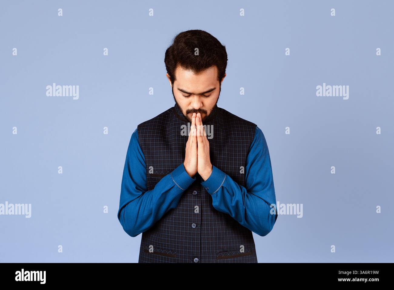 Peaceful Indian man praying to God on color background Stock Photo - Alamy